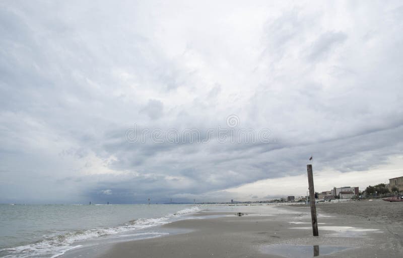 Cloudy Sky Over a Sandy Beach Stock Image - Image of windy, rocks: 99514377