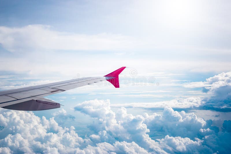 Cloudy Sky and Red Airplane Wing As Seen through Window on Aircraft ...