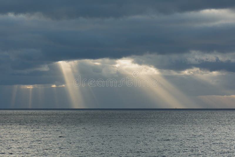 Cloudy Sky with Sun Rays in the Open Sea Stock Image - Image of cloudy ...