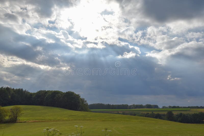 Cloudy Sky with Sunbeams Breaking through a Field Stock Image - Image ...