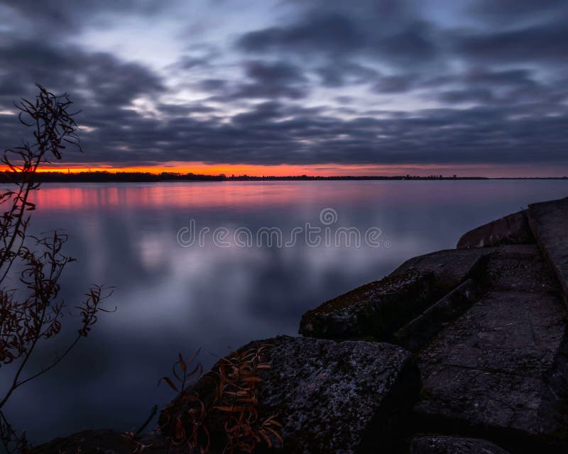 Cloudy Sky at Sunset is Reflected on the Water Surface of the River ...