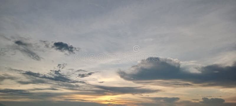 A Cloudy Sky at Sunset, Showing Various Cloud Formations Ranging from Thick Dark Clouds To Thin ...