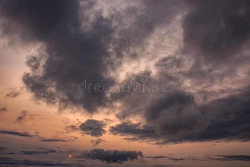 Cloudy Sunset Background with the Orange Sun Breaking through the ...