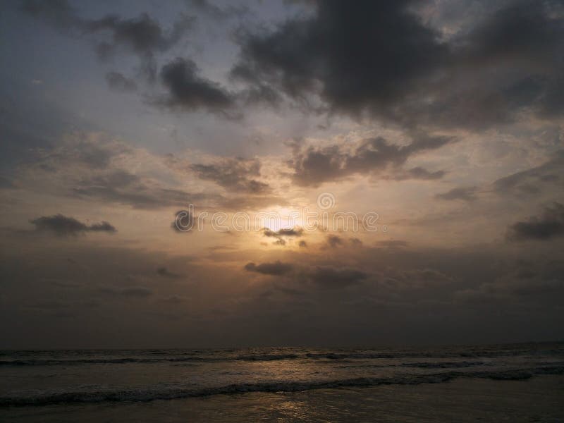 A Cloudy Sunset on the Beach Stock Photo - Image of sunset, water ...