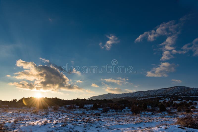 Cloudy Sunset in Snow Field with Mountain Stock Image - Image of orange ...