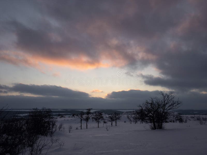 Cloudy sunset in winter stock photo. Image of evening - 136724698
