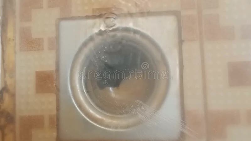 Cloudy Water Flows into the Bathroom Drain because the Faucet is Open ...