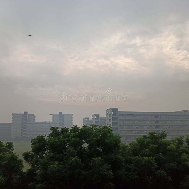 Cloudy Weather Building Under Sky and Trees in Front Stock Photo ...