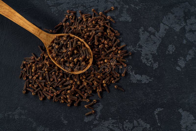Cloves Spice in a Wooden Spoon on a Light Kitchen Table, Top View Stock ...