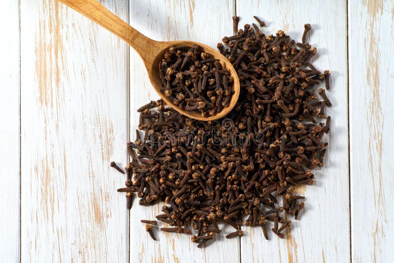 Cloves Spice in a Wooden Spoon on a Light Kitchen Table, Top View Stock ...