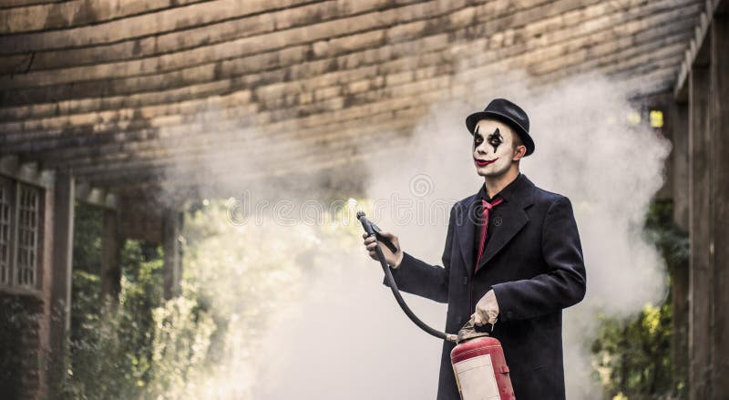 Clown with Fire Extinguisher Stock Photo - Image of fear, spraying ...