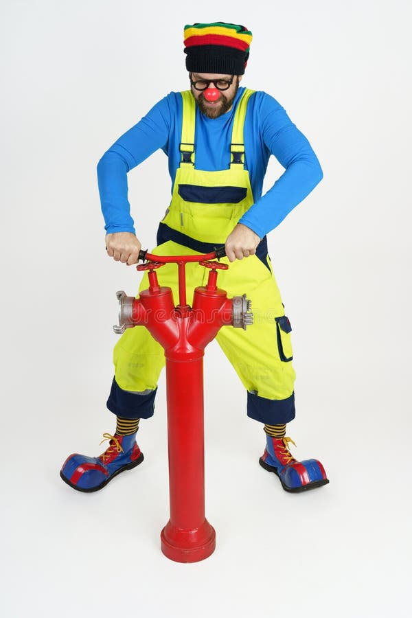 The Clown Fireman Turns the Valve on the Fire Hydrant Stock Photo ...