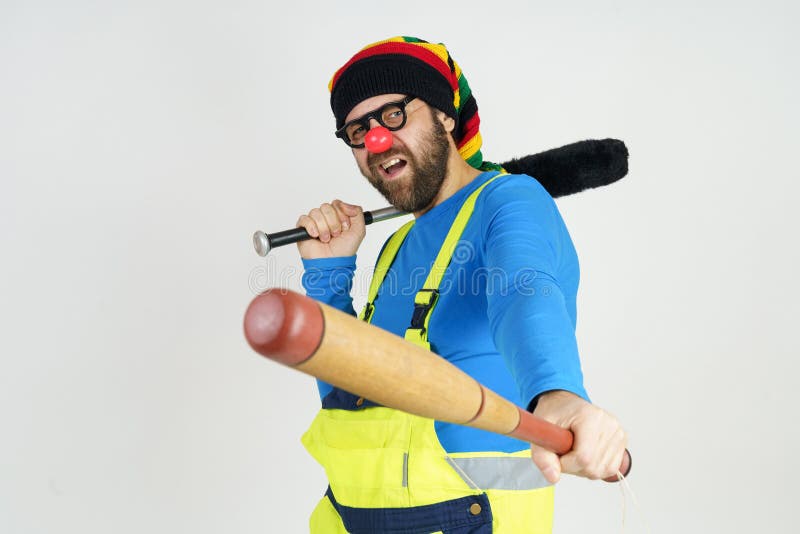The Clown Holds Baseball Bats in His Hands. Isolated on White Stock ...