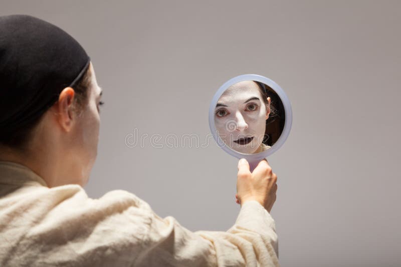 The Clown is Sitting on the Ground with a Mirror in His Hand Stock ...