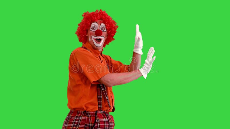 Clown Walking by and Making a Funny Look into Camera on a Green Screen ...