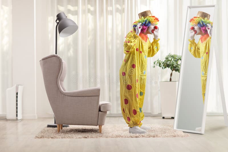Clown in a Yellow Costume Standing in Front of a Mirror at Home Stock ...