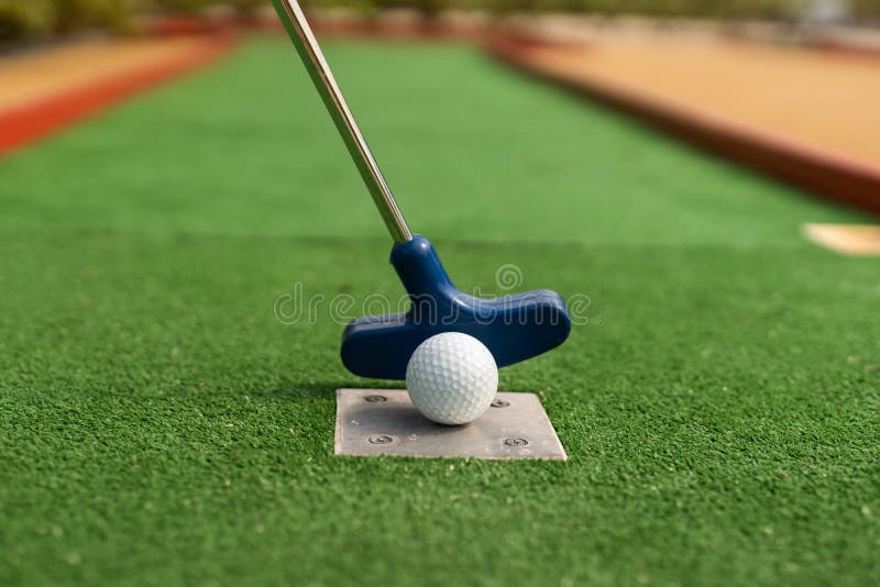 A Club Prepares To Hit a Ball during a Mini Golf Game Stock Photo ...