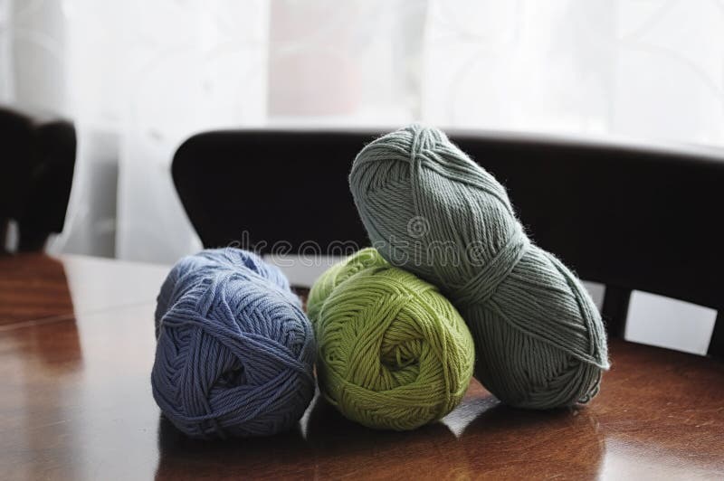 Clumps of Yarn and Knitting Needles on the Table Stock Photo - Image of ...