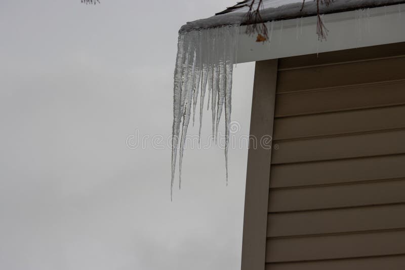 A Cluster of Icicles on the Corner of the Roof Stock Image - Image of ...
