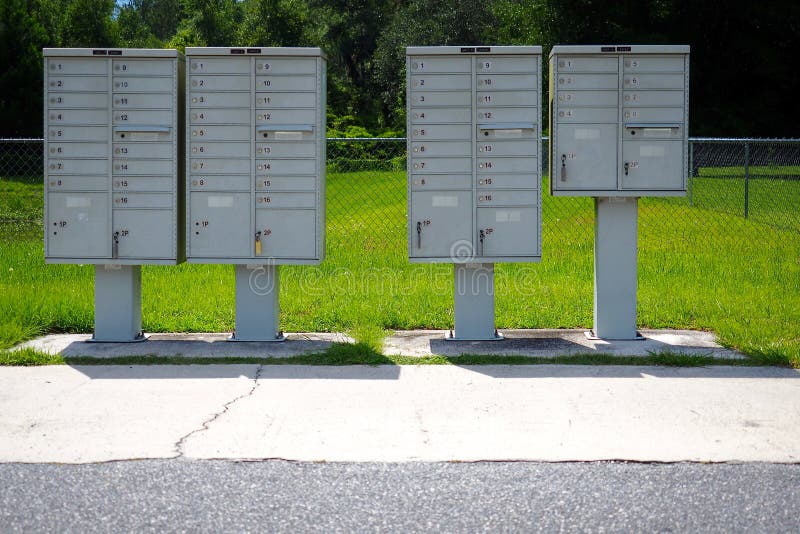 Row of Cluster Mailboxes with Numbered Compartments on the Sidewalk ...