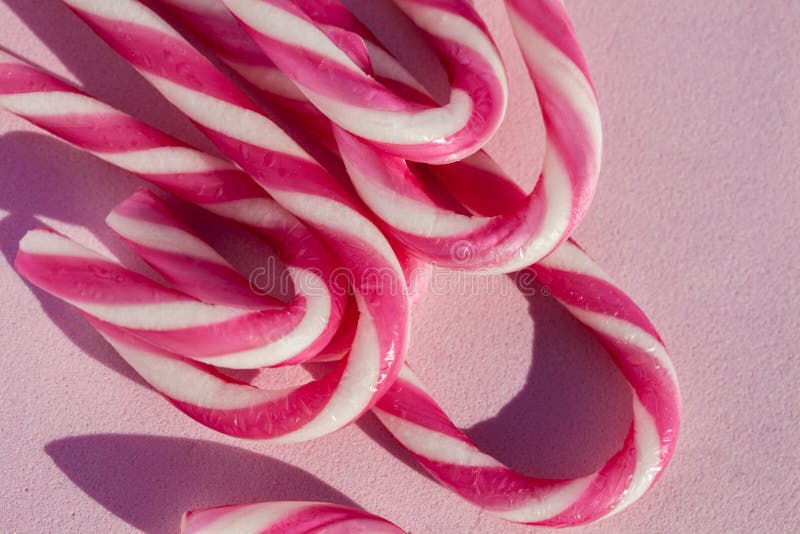 Cluster of Pink and White Candy Canes on a Pastel Pink Surface Stock ...