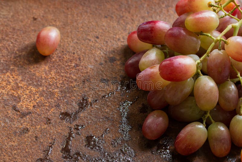 Cluster of Red Grapes on a Rusty Metal Surface. Stock Image - Image of ...