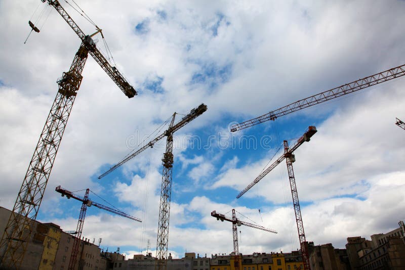 A Cluster of Tower Cranes. Construction of Apartment Buildings Stock ...
