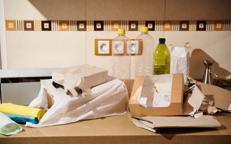 Cluttered Kitchen Counter with Disposable Packaging and Bottles in ...