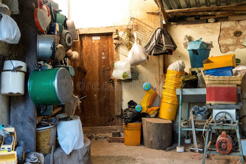 Cluttered Storage Area Filled with Various Containers and Tools in a ...