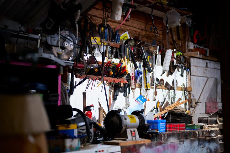 A Cluttered Workshop with Tools and Equipment on Shelves Editorial ...