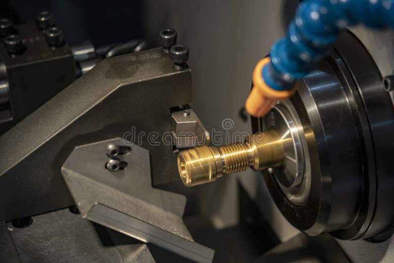 The CNC Lathe or Turning Machine Cutting the Thread at the Brass Shaft ...