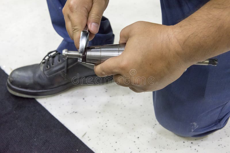 The CNC Machine Operator Tighten the Pull Stud Stock Image - Image of ...