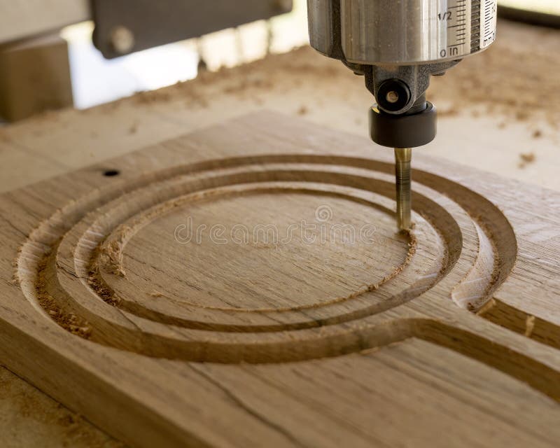 A CNC Machine Routing a Wood Board Stock Photo - Image of snake ...