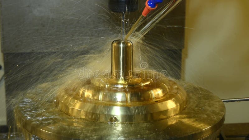 The CNC Milling Machine Cutting the Brass Shell Mold Part with Oil ...