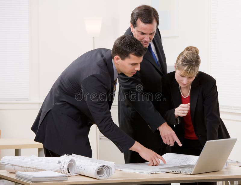 Co-workers Collaborating on Blueprints Stock Image - Image of ...