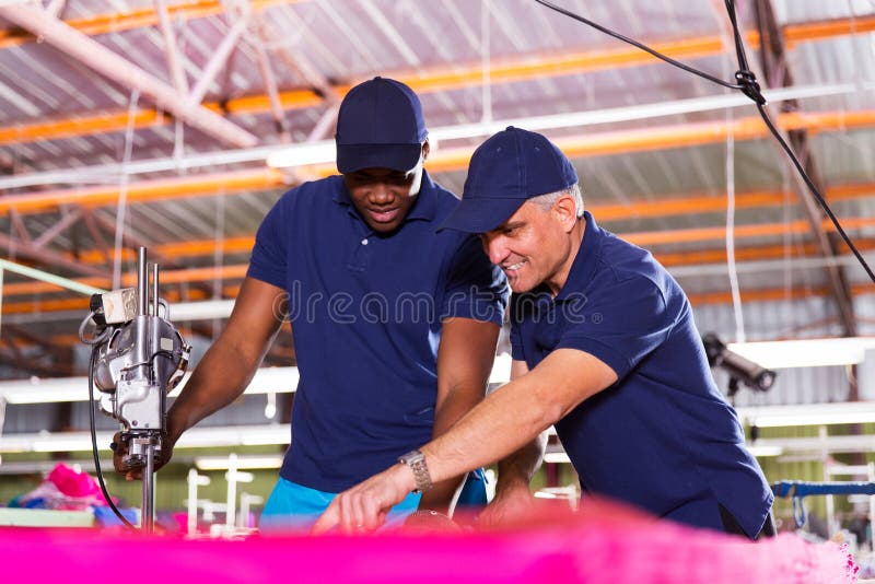 Co-workers cutting fabric stock image. Image of factory - 45443669