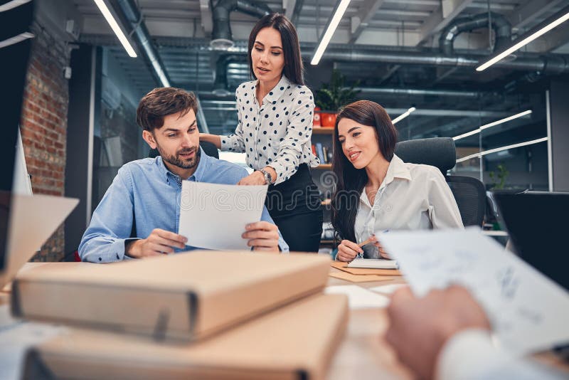 Co-workers Discussing Presentation of Business Project with Boss in ...