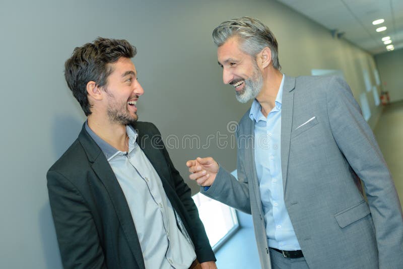Co-workers Laughing in Business Centre Hall Stock Image - Image of ...