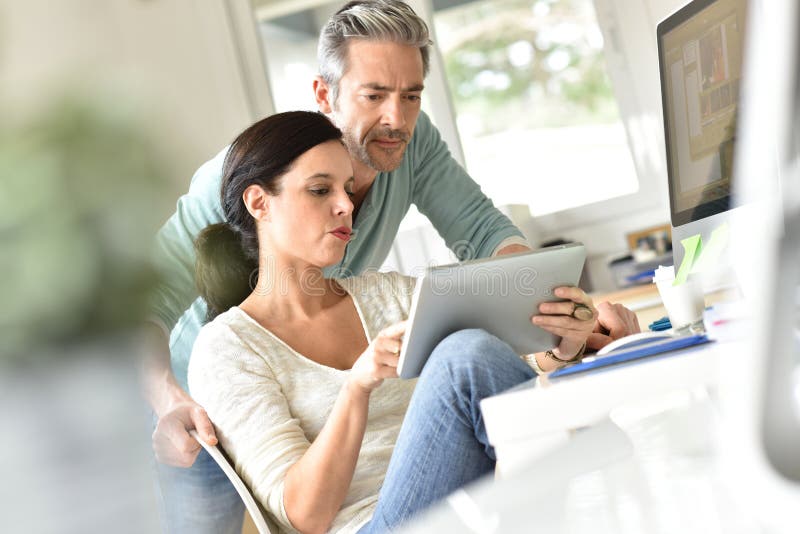 Co-workers in Office Using Digital Tablet Stock Photo - Image of desk ...