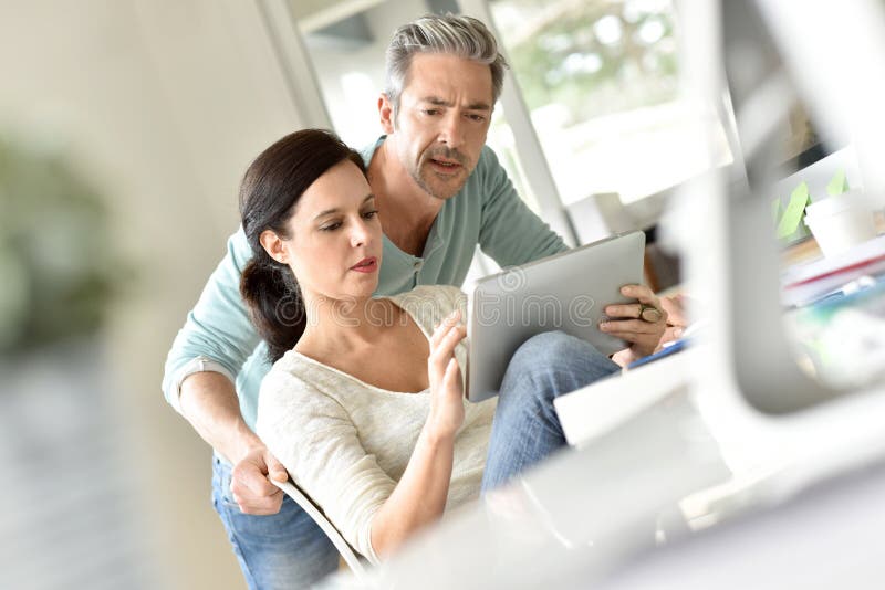 Co-workers in Office Using Digital Tablet Stock Photo - Image of start ...