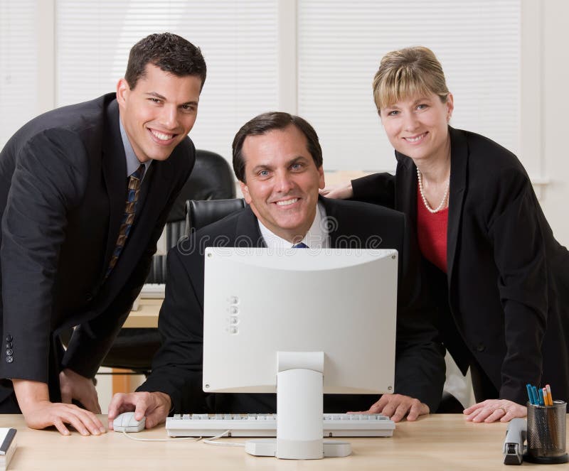 Co-workers Posing Together at Desk Stock Photo - Image of person ...