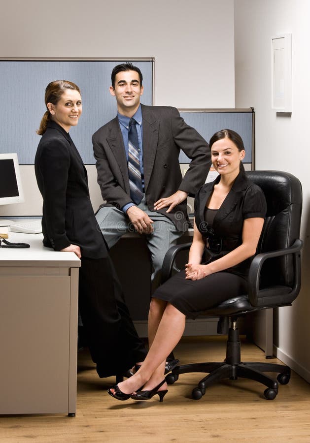 Co-workers Sitting in Office Cubicle Stock Photo - Image of socializing ...