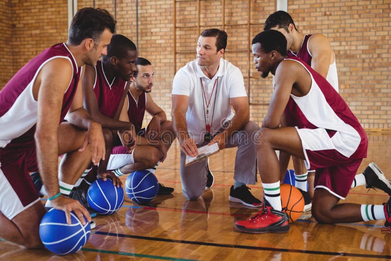 Coach Explaining Game Plan To Basketball Players Stock Photo - Image of ...