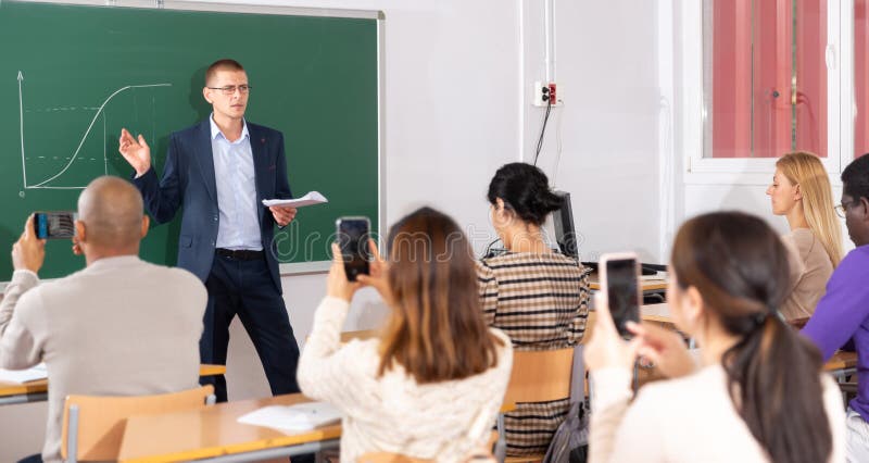 Coach Giving Presentation for Adult Audience in Lecture Hall Stock ... Coach Giving Presentation for Adult Audience in Lecture Hall Stock ...