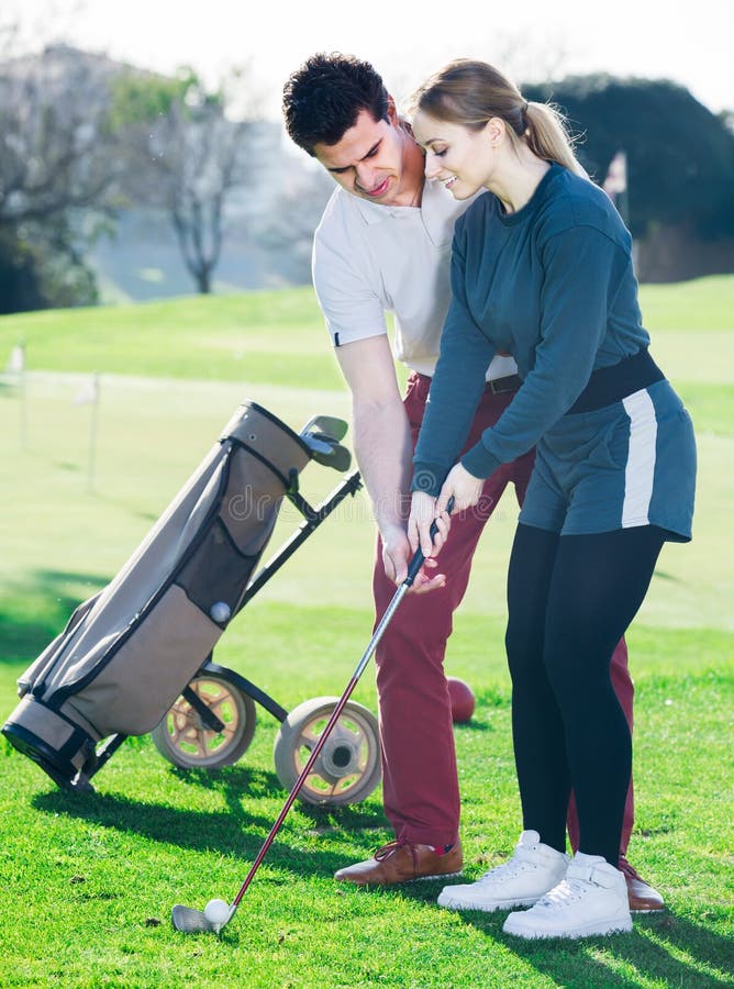 Coach Helping a Girl Prepare for the Game of Golf Stock Photo - Image ...