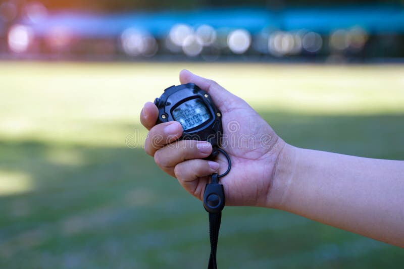 Coach Holds a Stopwatch To Check the Runners Speed Statistics during ...