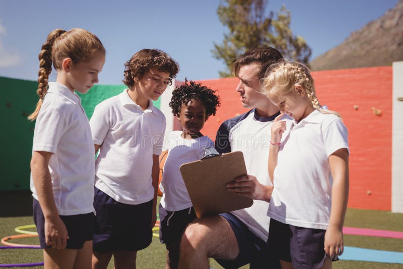 Coach and Schoolkids Discussing on Clipboard Stock Image - Image of ...