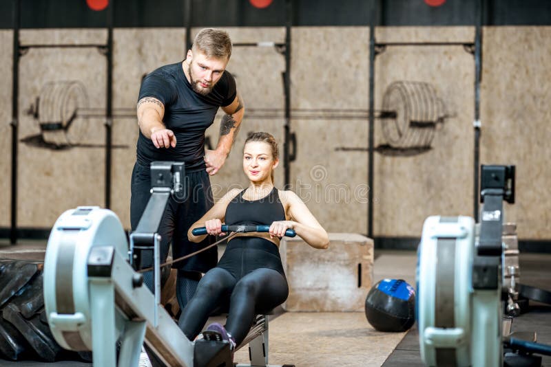 Coach Training Woman on the Exercise Machine Stock Photo - Image of ...