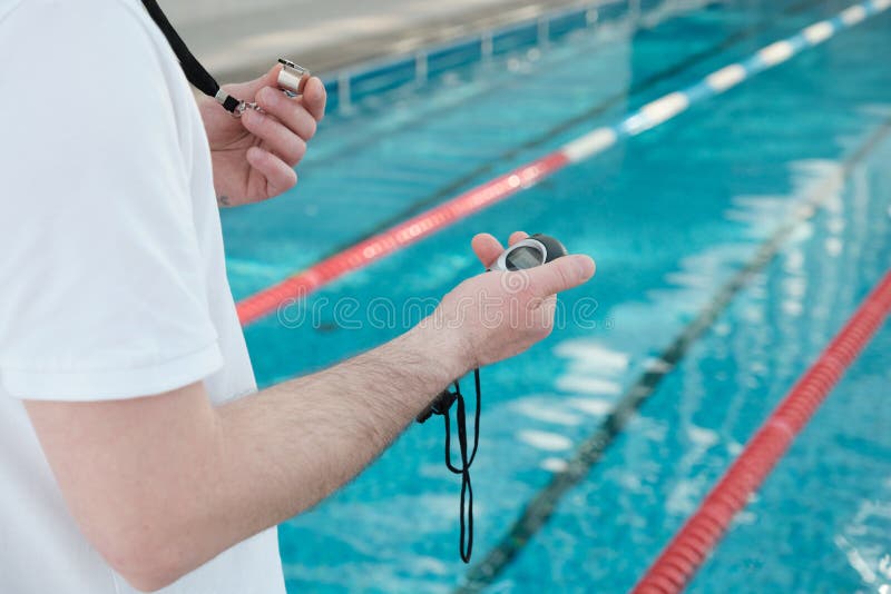 Coach Using Stopwatch at Swimming Training Stock Photo - Image of ...