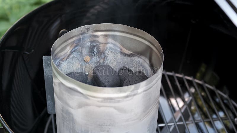 Coal Ignition Tank and Smoke on Background of Black Round Grill. Close ...